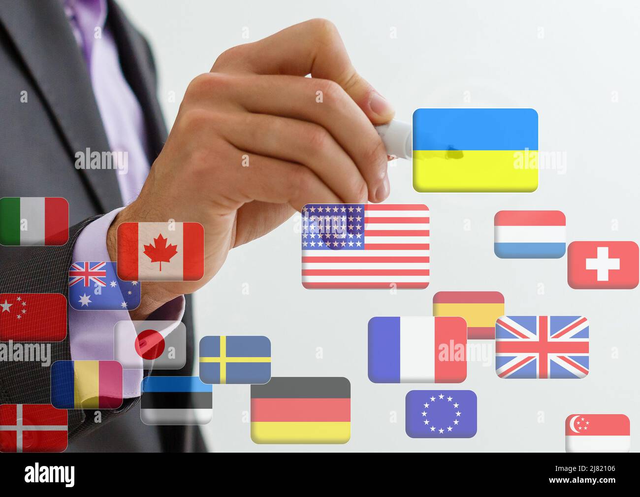 Hand pushing on a touch screen interface, choosing Ukraine. flags of ...