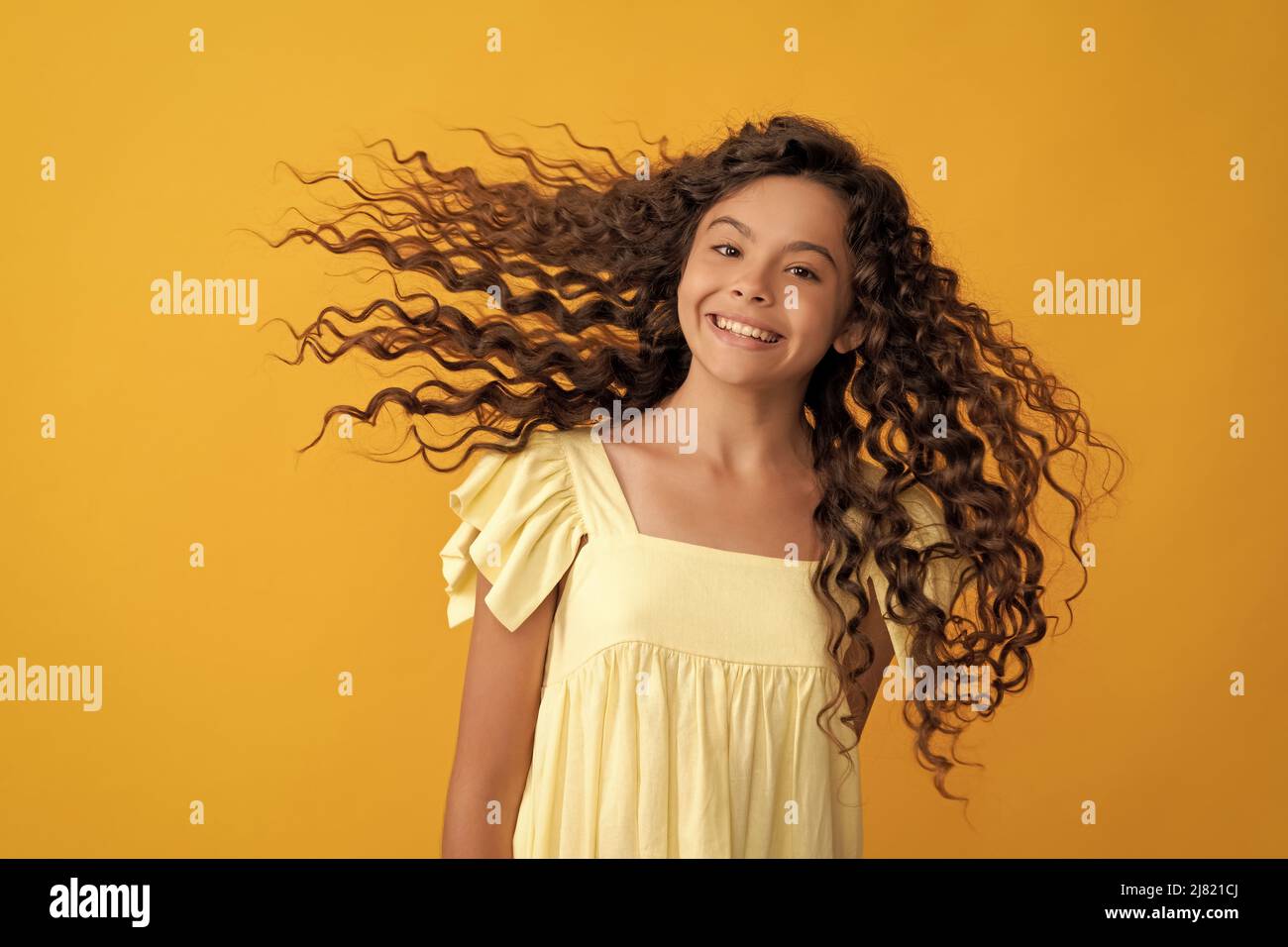 happy kid with long curly hair and perfect skin, volume hair Stock ...