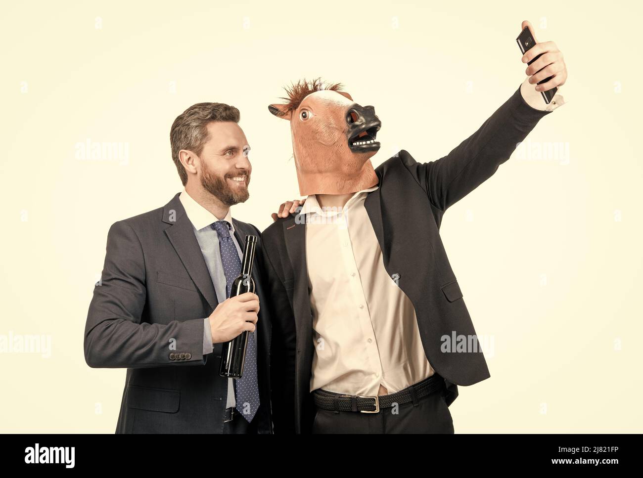 Happy professional man in horse head mask and drunk manager take self ...