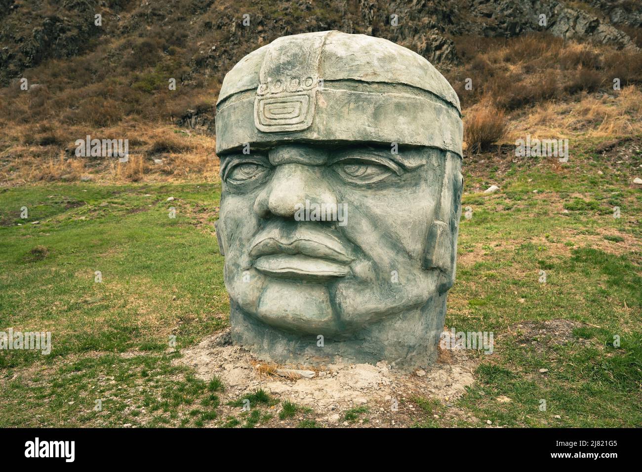 Olmec sculpture carved from stone. Mayan symbol - Big stone head statue ...