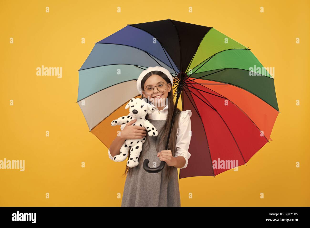 happy teen girl under colorful umbrella in autumn season hold toy ...