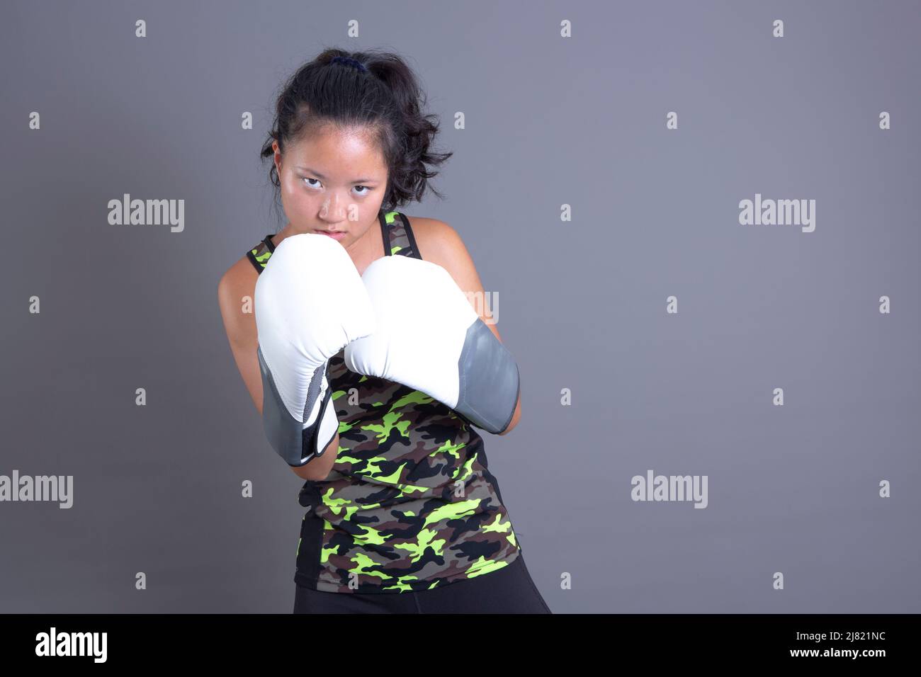 asian ethnicity sportswoman with boxing gloves Stock Photo - Alamy