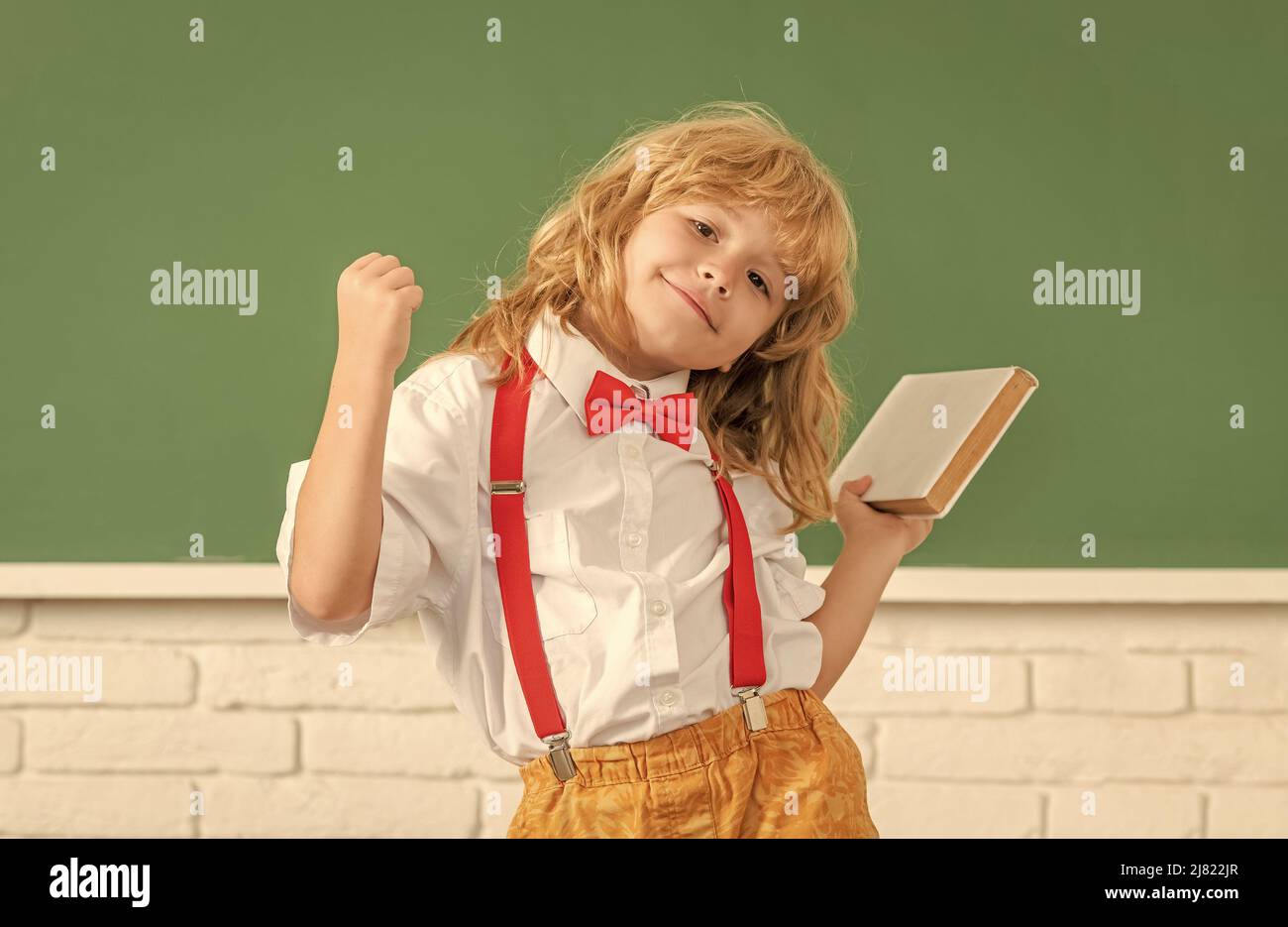 nerd kid with long hair at blackboard. september 1. childhood ...