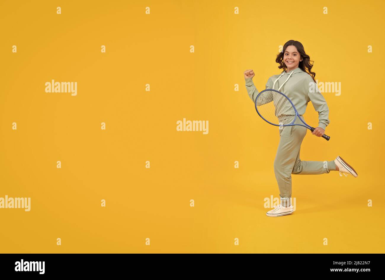 happy energetic teen girl jump with badminton racquet running to ...