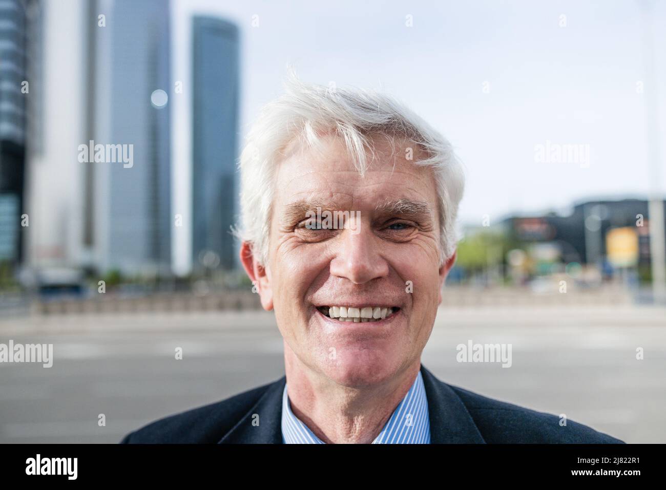 Senior business man working outside of the office with city in ...