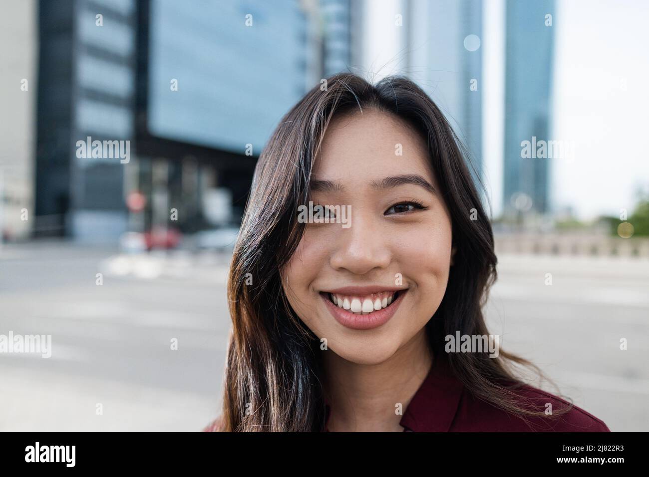 Asian business woman working outside of the office with city in ...