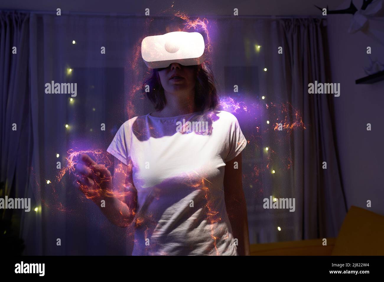 Woman is using virtual reality headset. Elements of this image ...