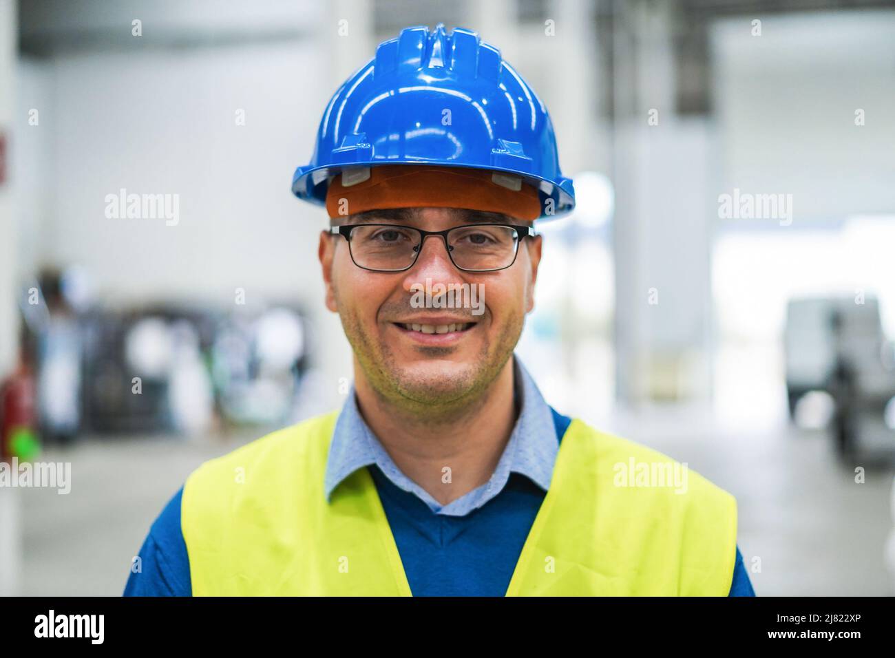 Happy engineer working inside robotic factory - Industrial and ...