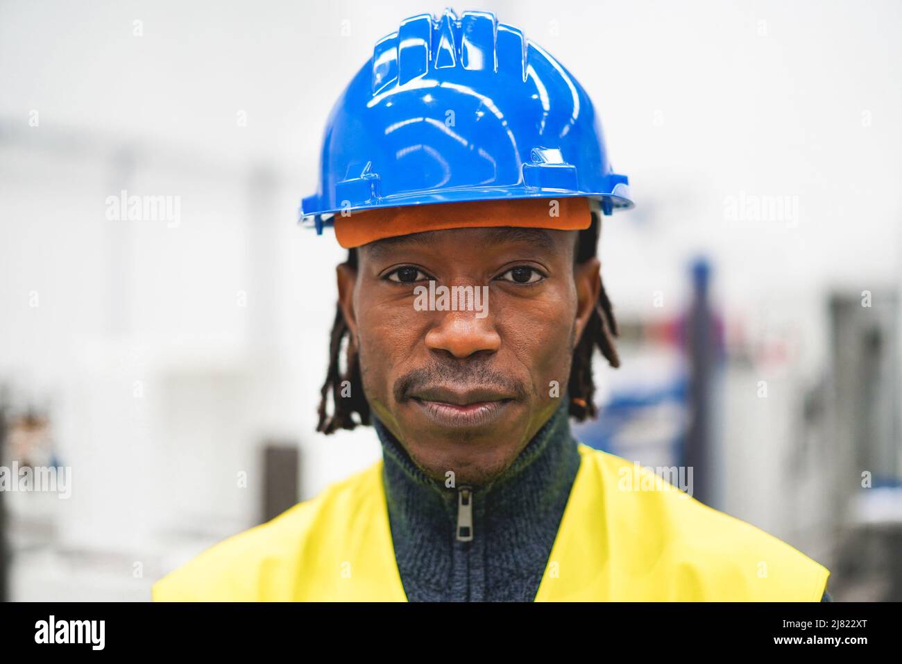 African engineer working inside robotic factory - Industrial and ...