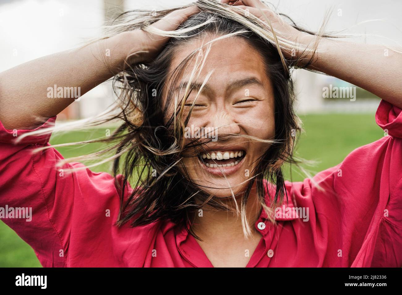 Asian girl smiling on camera outdoor - Focus on face Stock Photo - Alamy