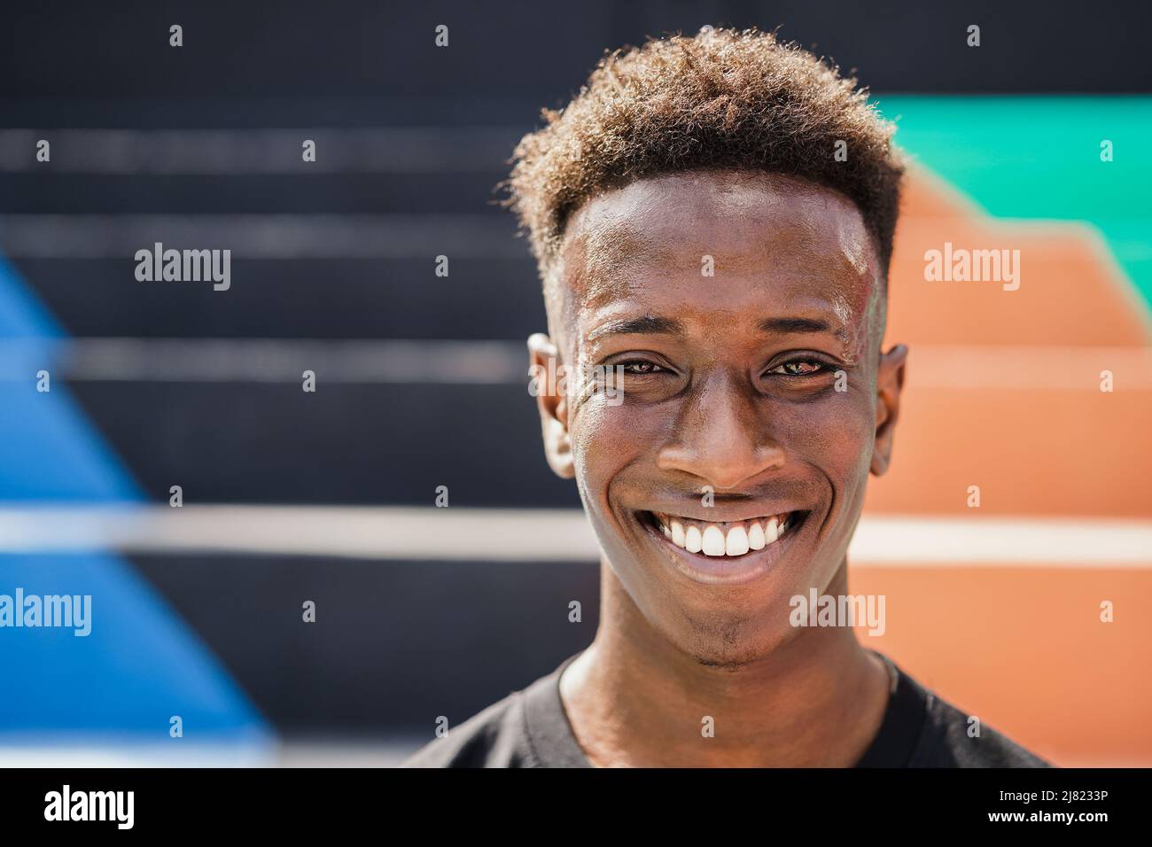 Happy African man smiling at camera outdoor - Focus on face Stock Photo ...