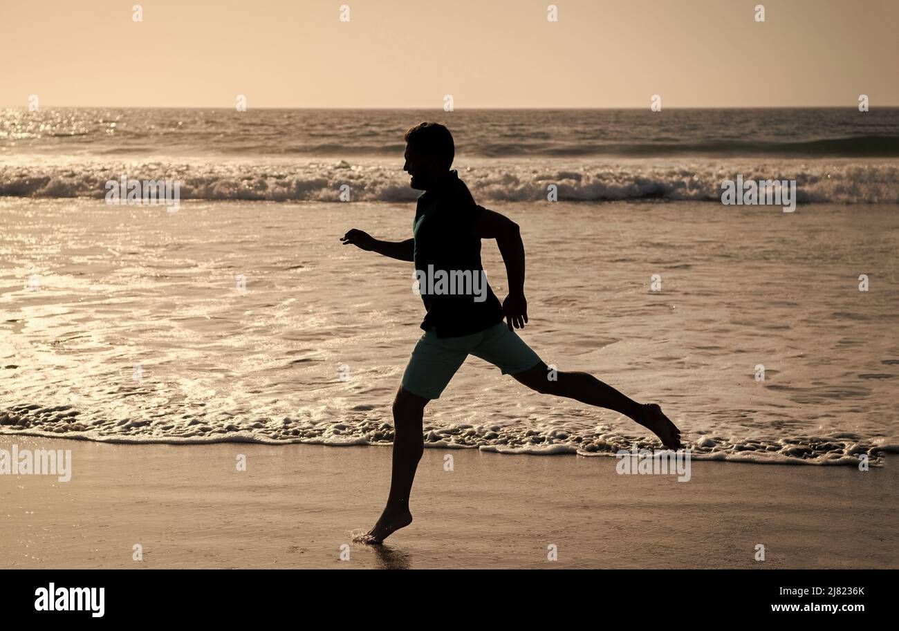 morning workout activity. sporty man running on beach. energetic summer ...