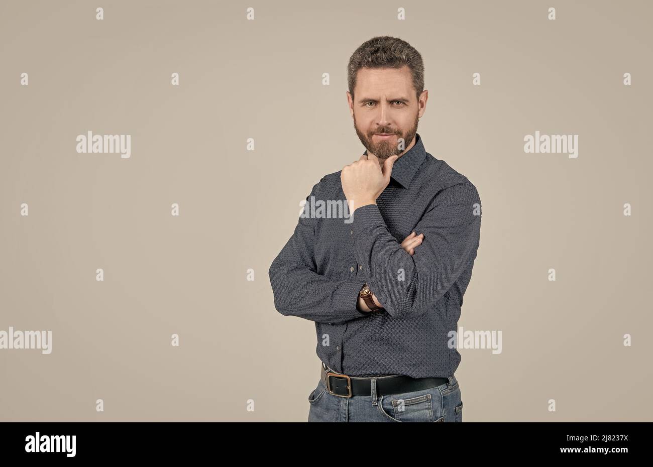 Without compromising on style. Middle-aged man touch bearded chin ...