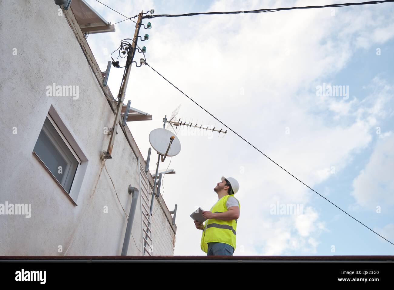Technician checking electric wire power lines and telephone pole Stock ...
