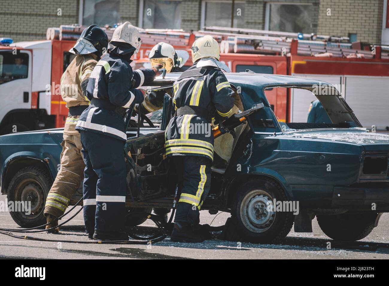 Fireman with protective overalls and work gloves while breaking a car ...