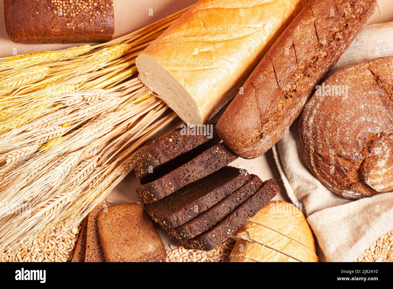 Wheat ear with different types of bread top view Stock Photo - Alamy