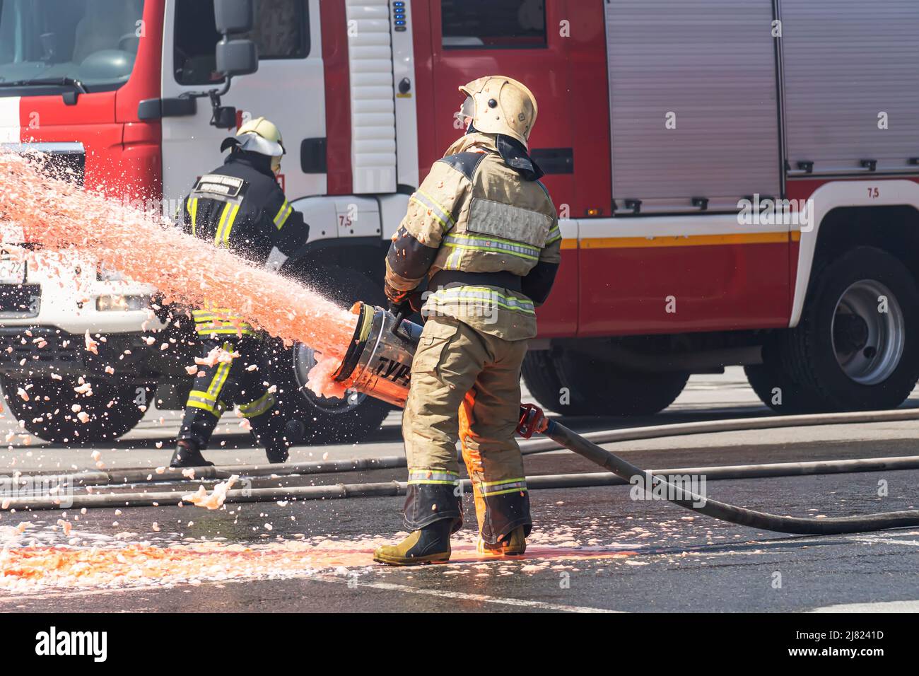 Firefighter - Firemen extinguishing a large blaze, they are standing ...
