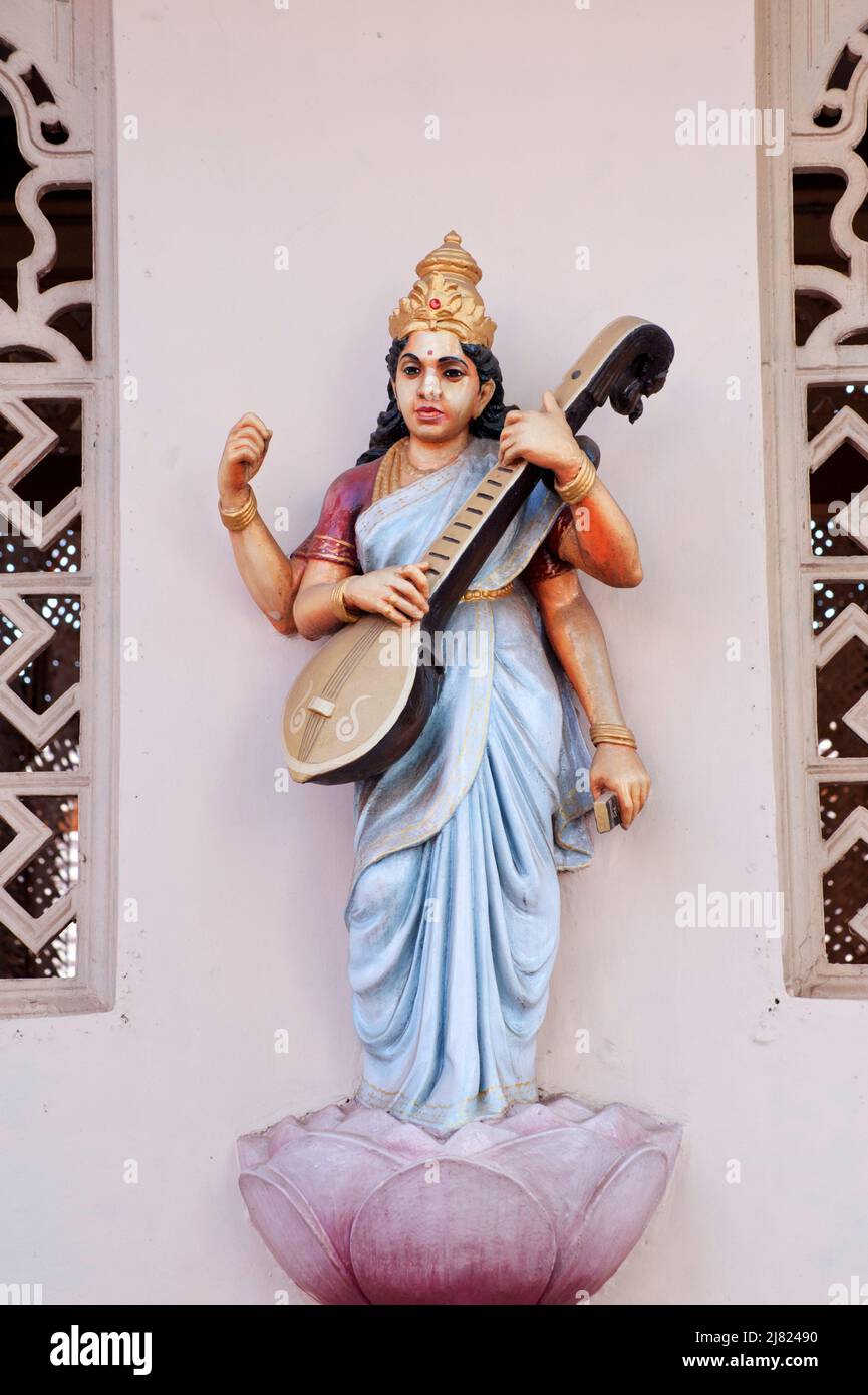 Statue of a Hindu Goddess Saraswati on the wall of temple at Mangalore ...