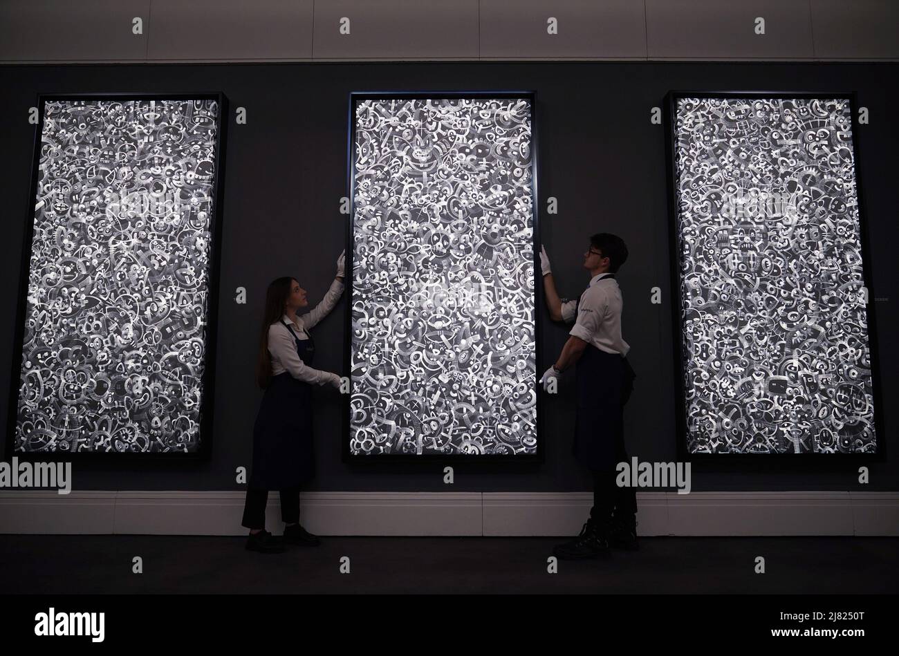 Art handlers next to a piece entitled Mandy at Sotheby's in London, for ...