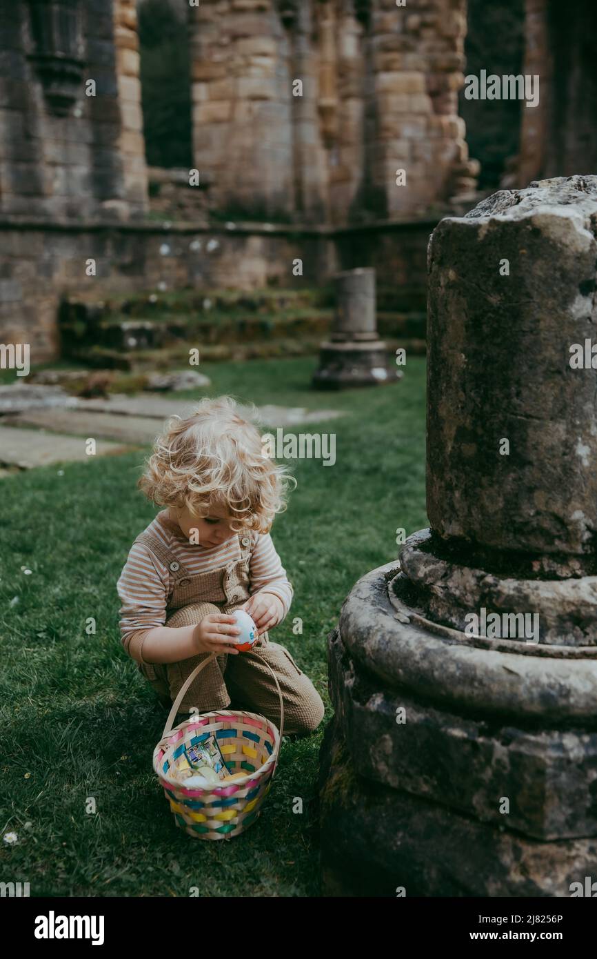 Boy toddler easter egg hunt outdoors cute Stock Photo - Alamy