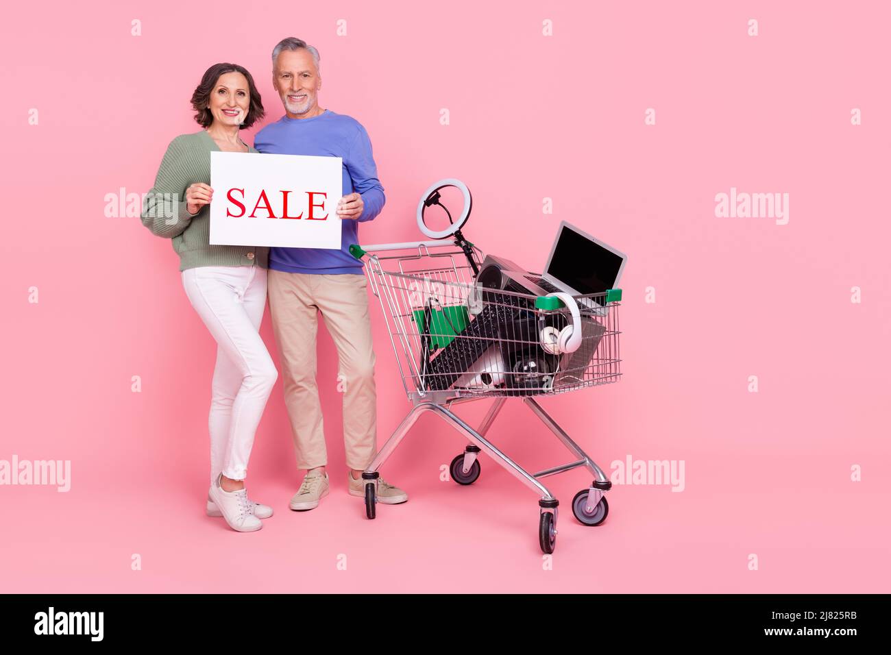 Full length photo of two positive persons hold paper poster placard ...