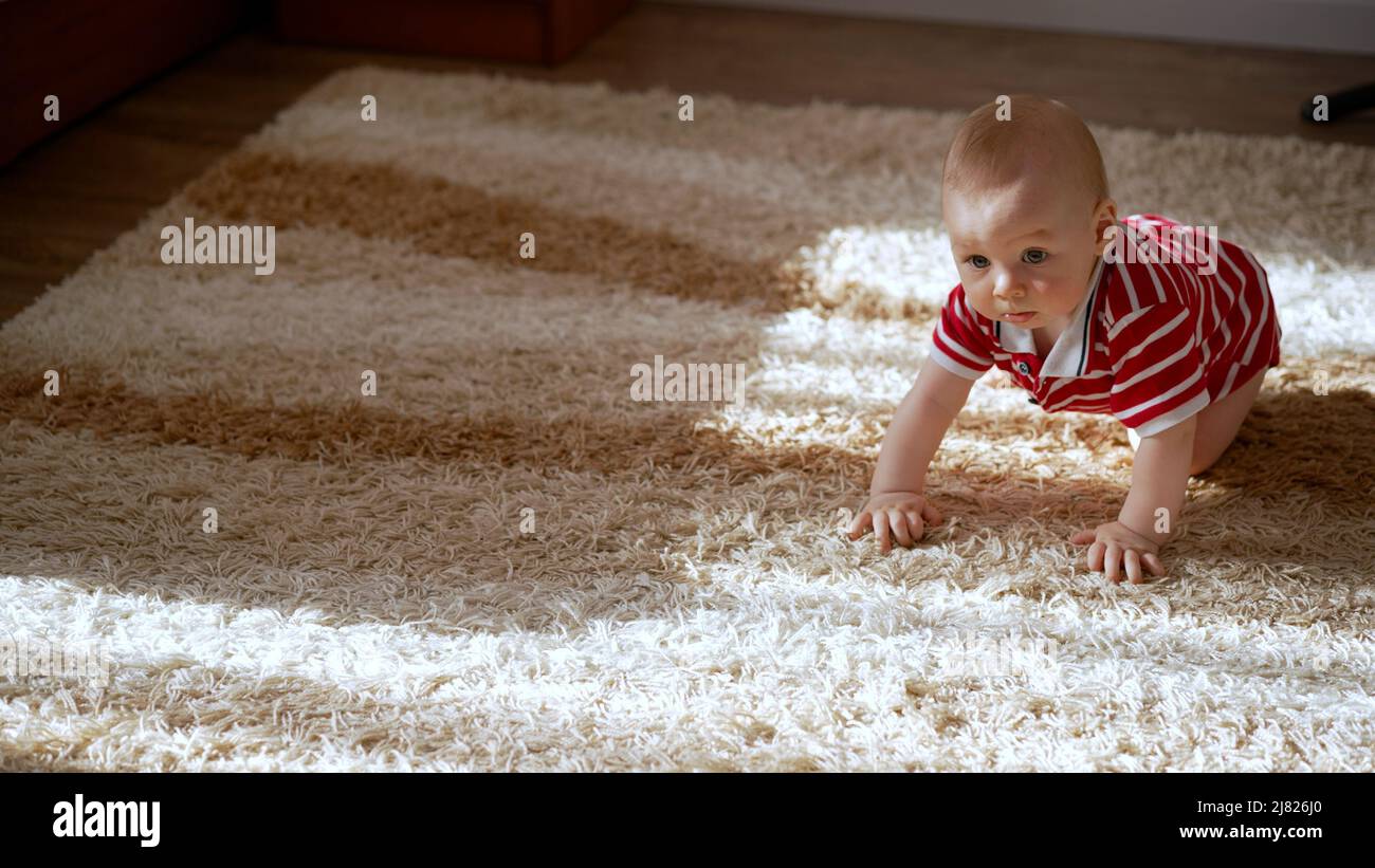 Little boy is learning to crawl. Newborn child learning crawling. Baby ...