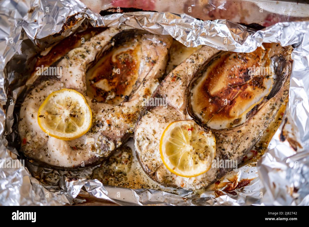 Baked fish silver carp steaks. Pieces of fish cooked in the oven in ...