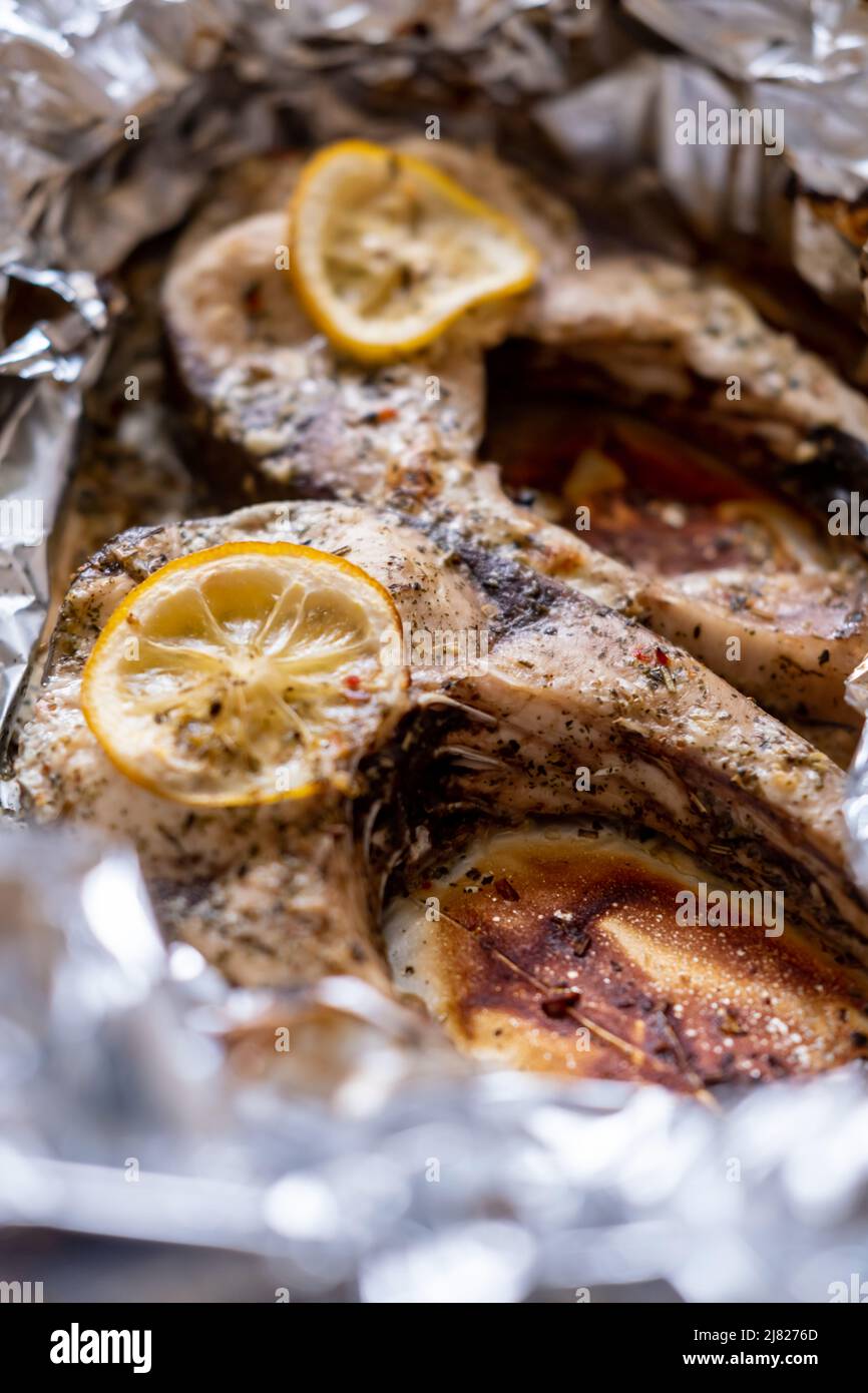 Baked fish silver carp steaks. Pieces of fish cooked in the oven in ...