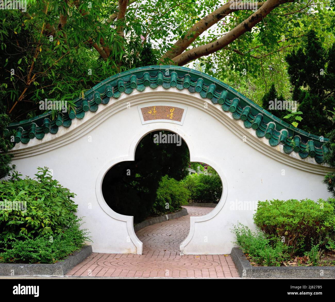 Traditional Chinese curved roof entrance inside an urban park, Hong ...