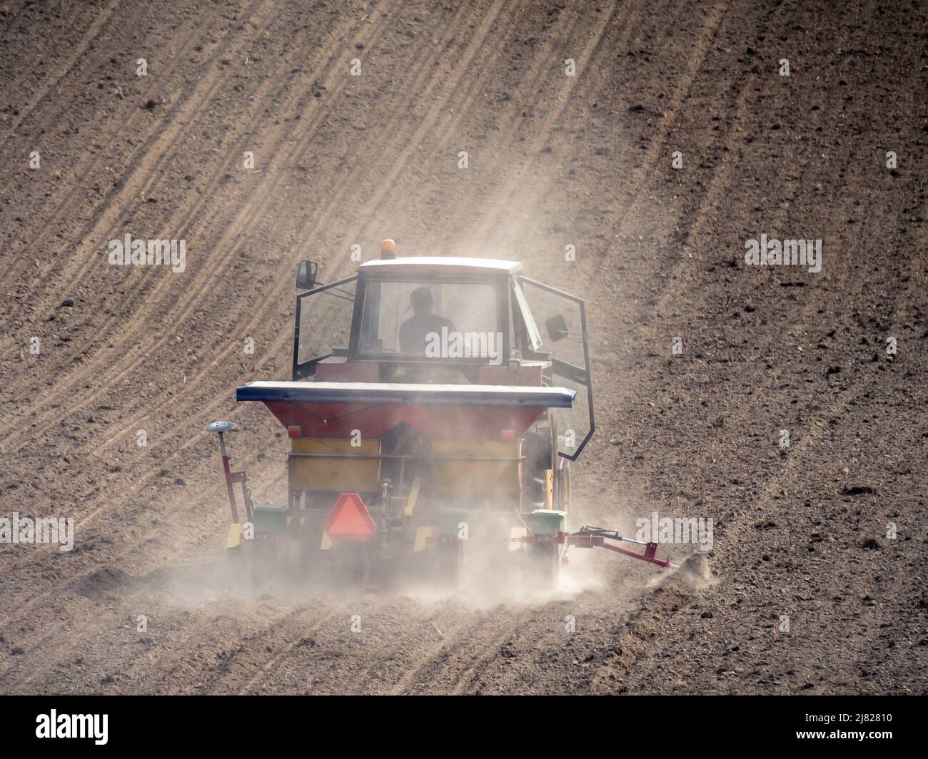 Arable field being planted by farm tractor with sowing machine Stock ...