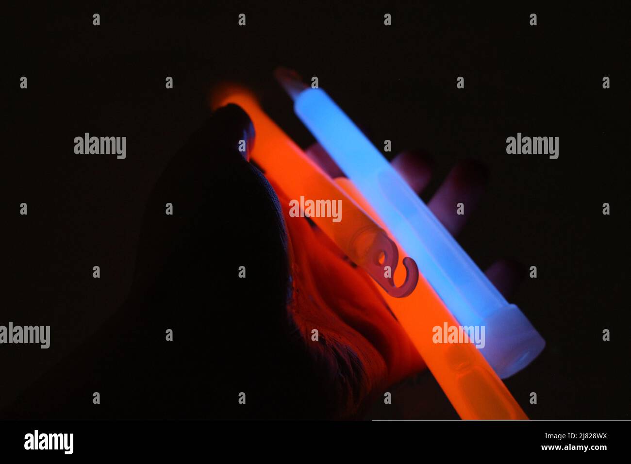 Holding glow sticks Stock Photo - Alamy