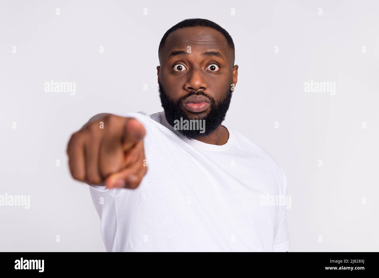 Photo of scared shocked guy dressed casual t-shirt pointing finger you ...