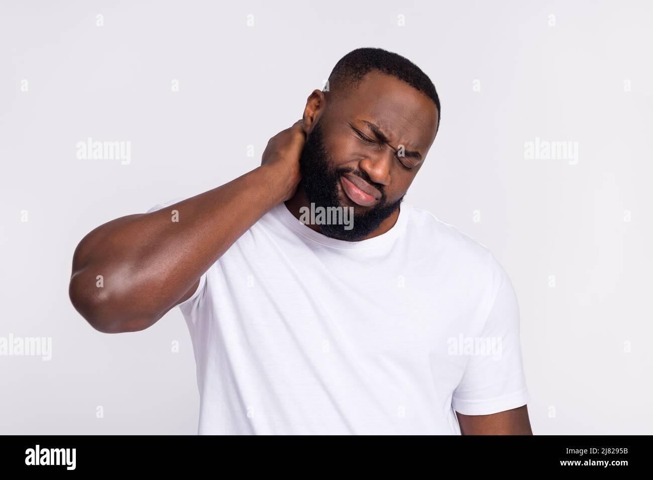 Photo of tired sad guy dressed casual t-shirt arm neck having head pain ...