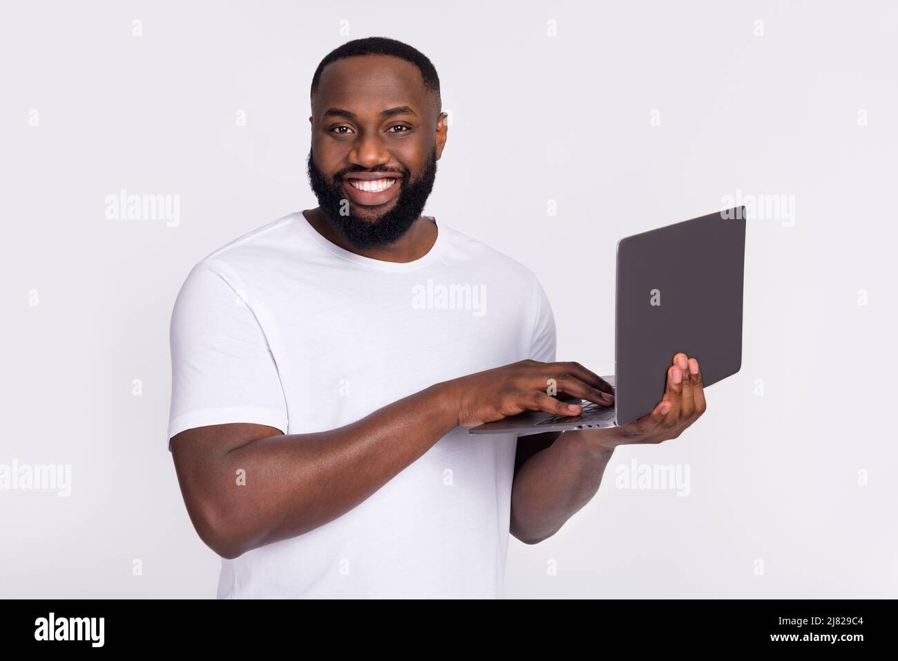Photo of pretty positive guy dressed casual t-shirt chatting modern ...