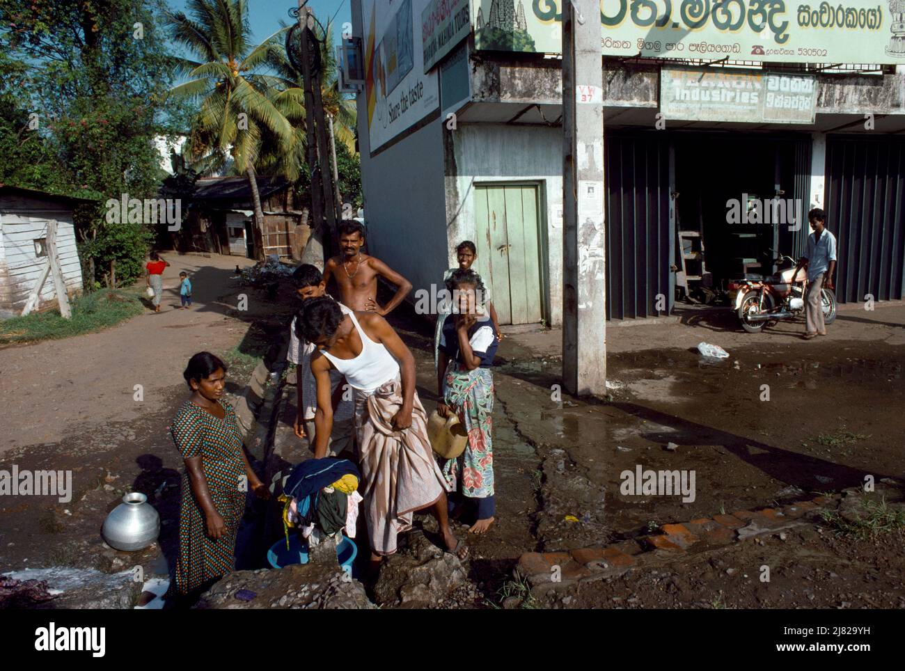 Colombo Sri Lanka People in Street Collectng Water Stock Photo - Alamy