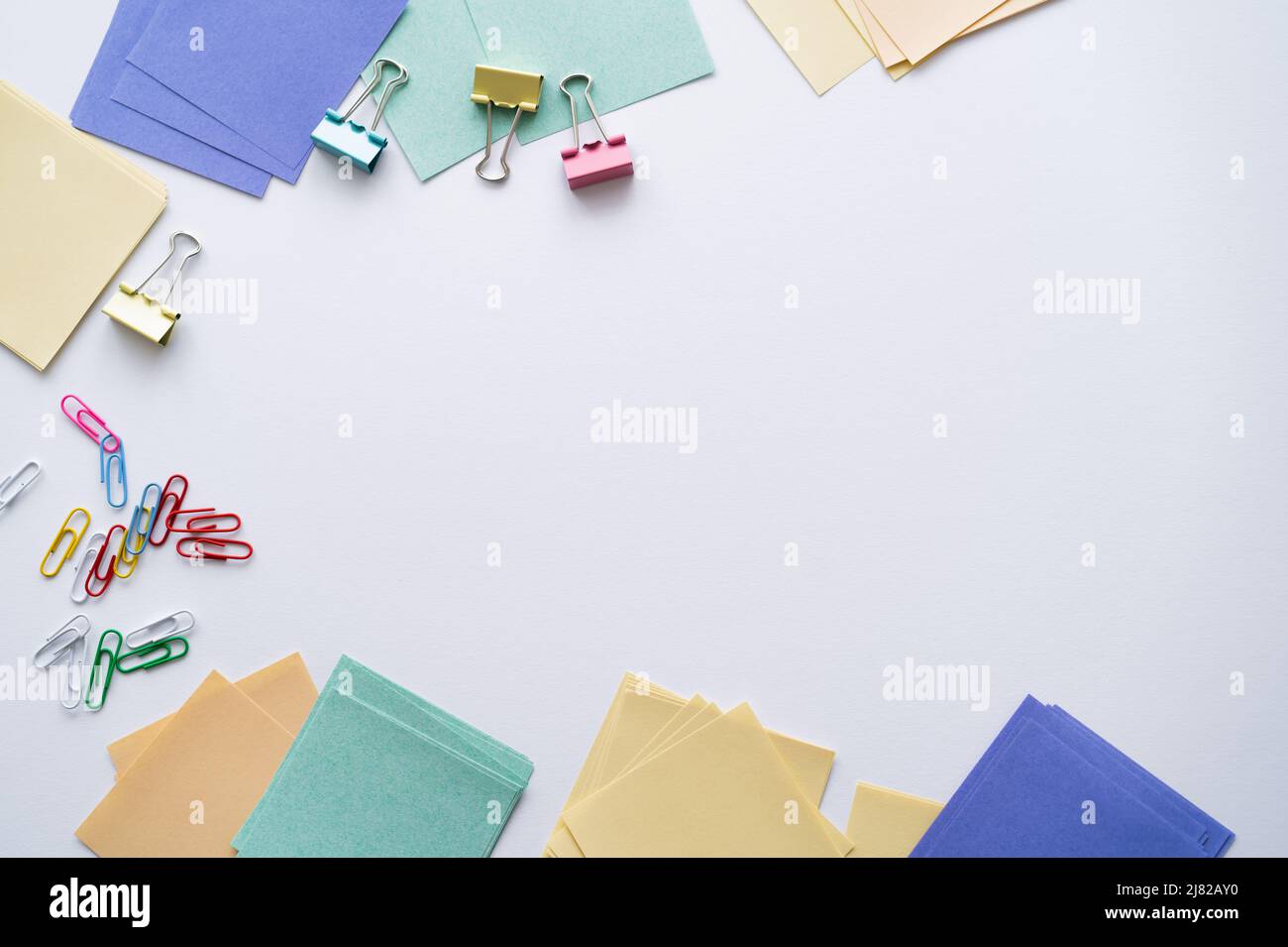 top view of colorful fold back clips and paper notes on white Stock ...