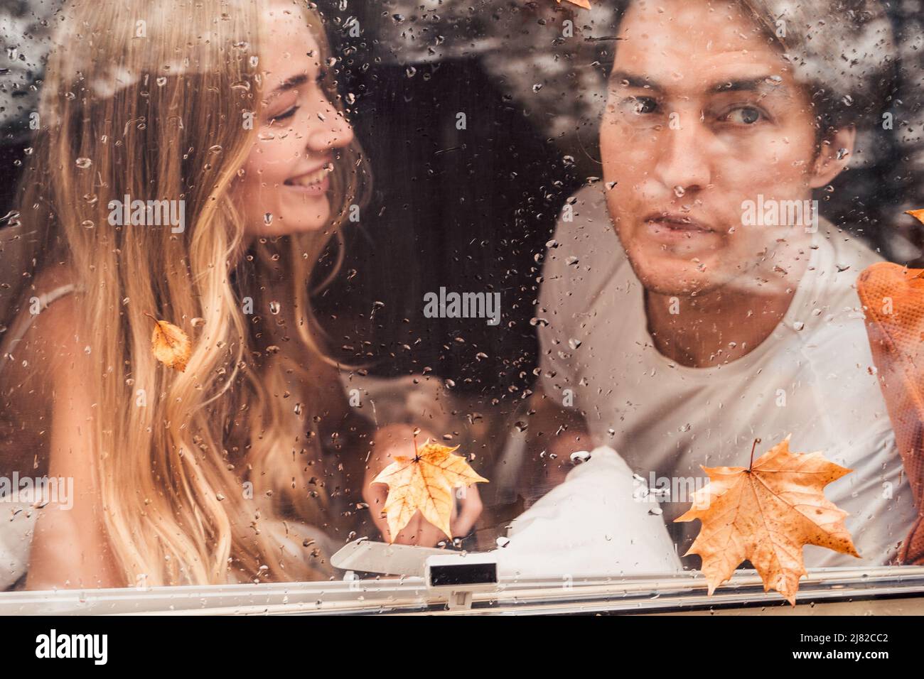 Young happy lovers couple behind wet misted window,rain drops.Drawing ...