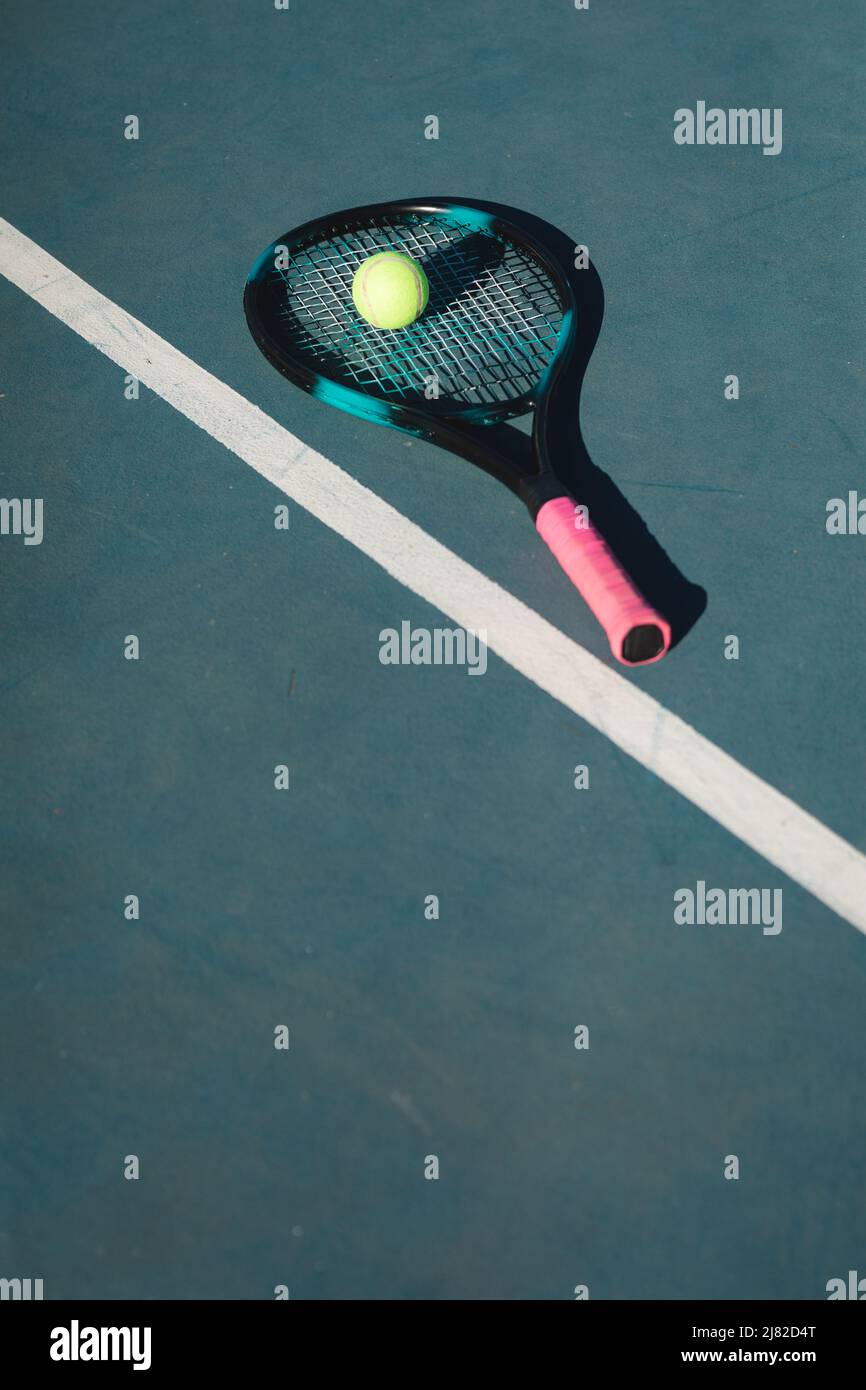 High angle view of tennis ball and racket by line on blue court during ...