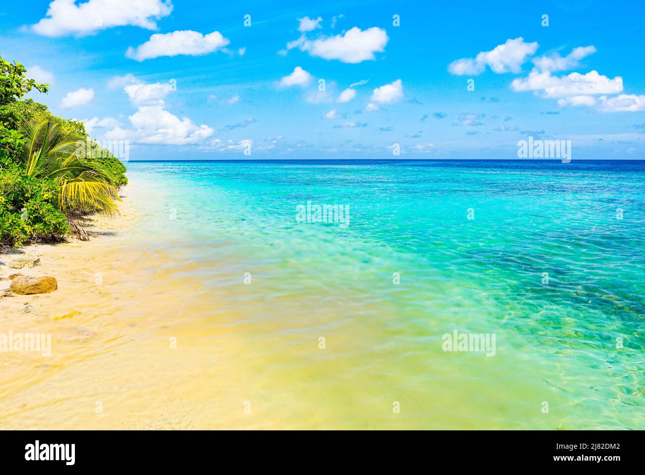 Shoreline of a tropical island in the Maldives and view of the Indian ...