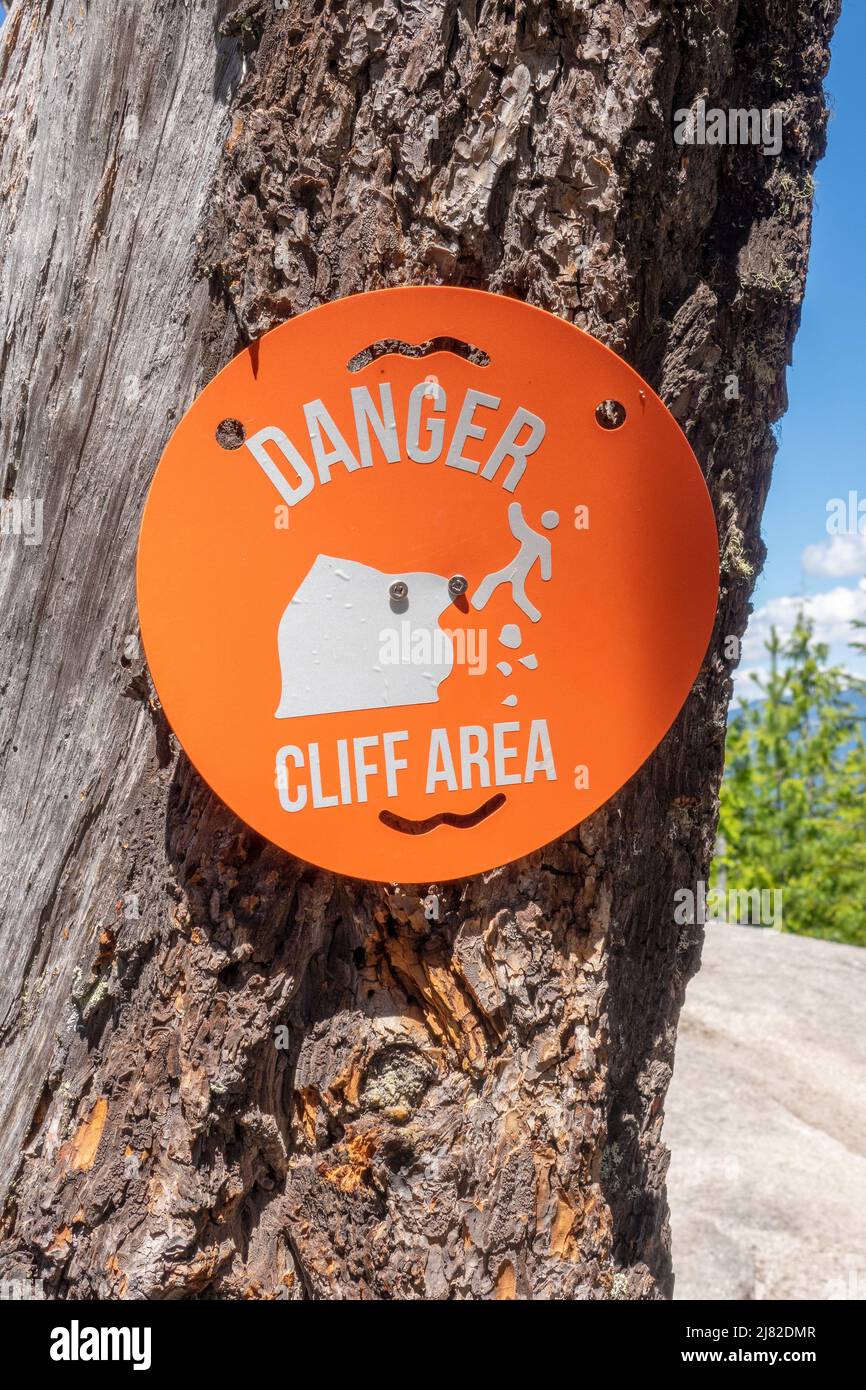 Warning Sign Nailed To A Tree About Falling From A Cliff In The Hills ...