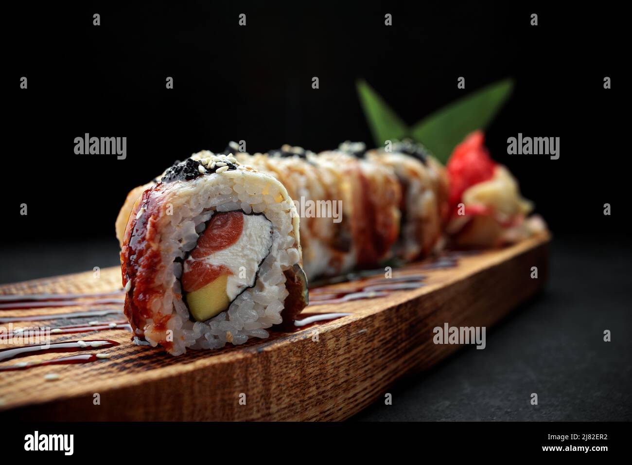 Sushi roll Golden dragon, on a wooden board Stock Photo - Alamy