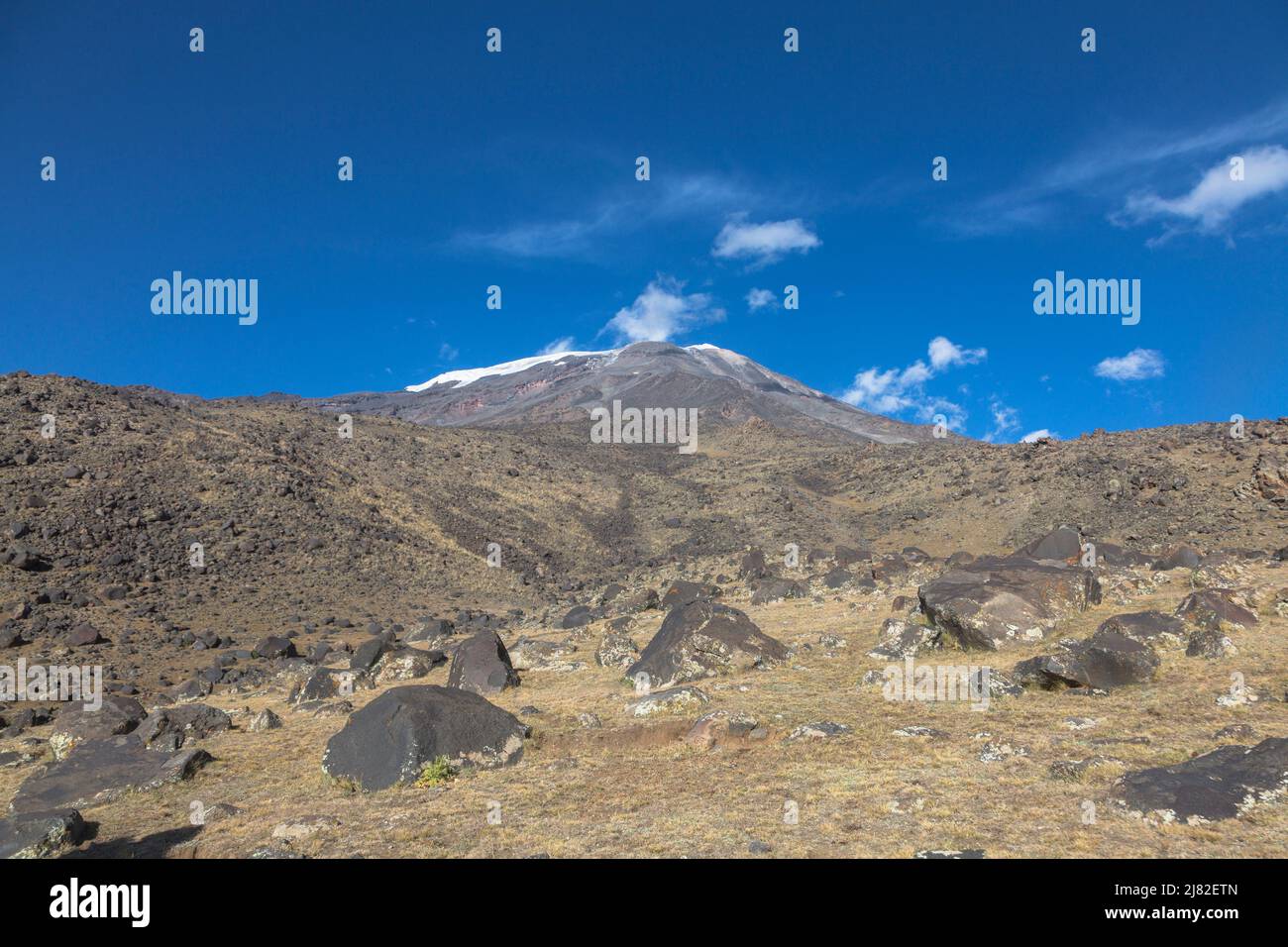 volcanic lava in the background of the ice cap on the summit of the ...