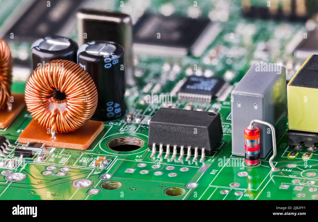 Coil or varied electronic components on green printed circuit board ...