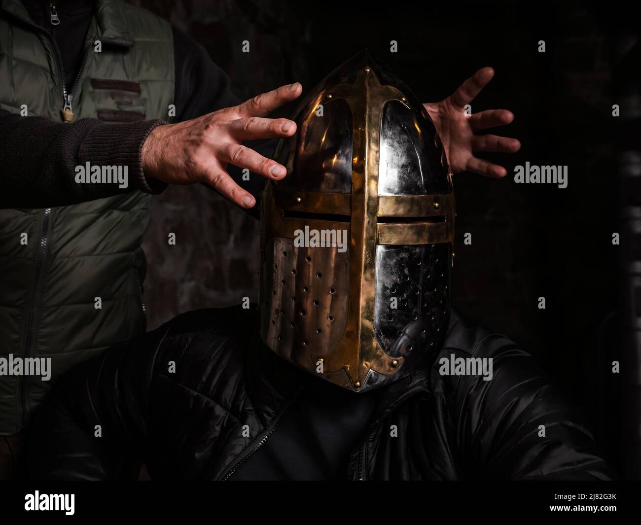 A man in a medieval iron knight's helmet. Armor Stock Photo - Alamy