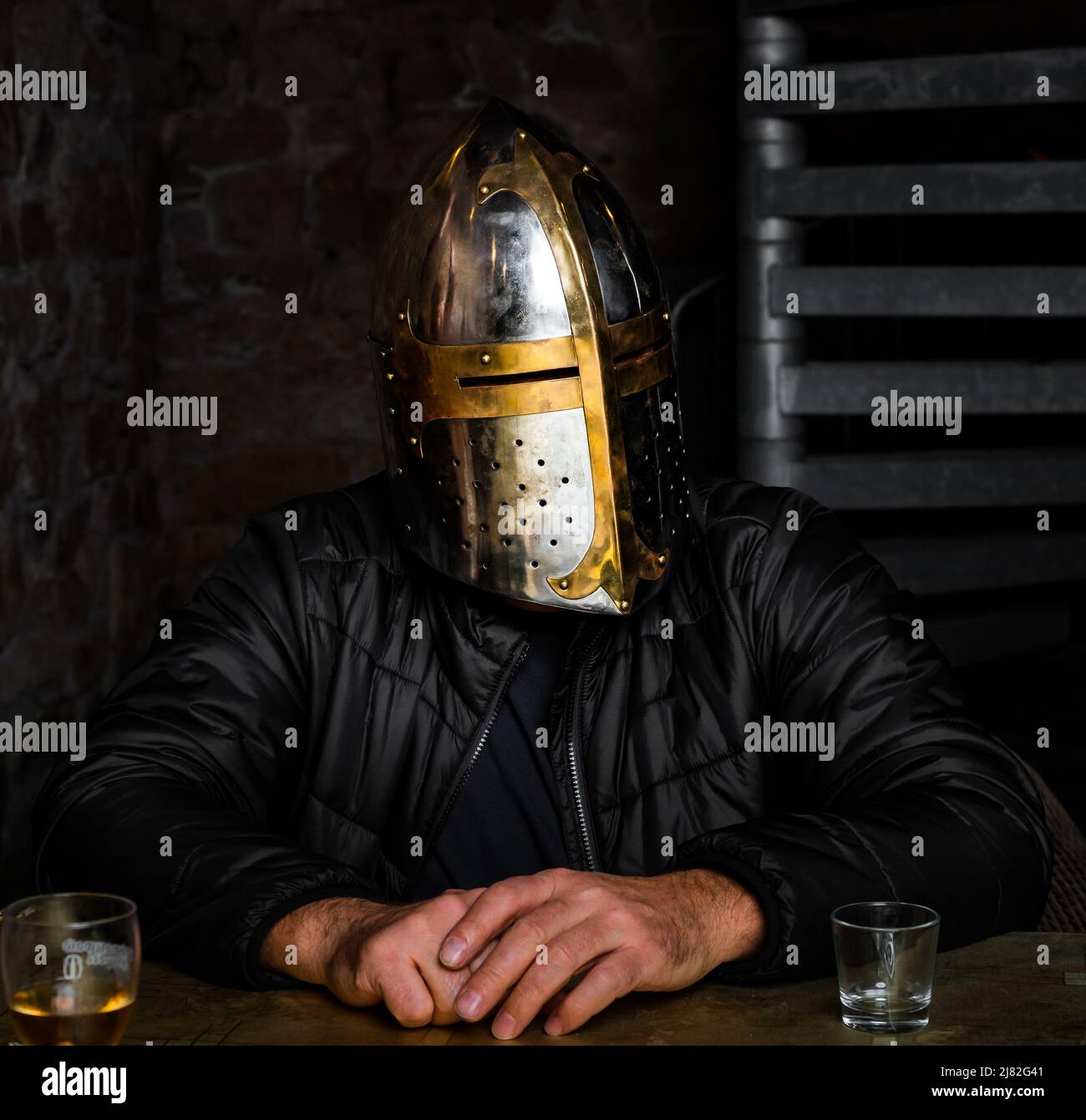A man in a medieval iron knight's helmet. Armor Stock Photo - Alamy