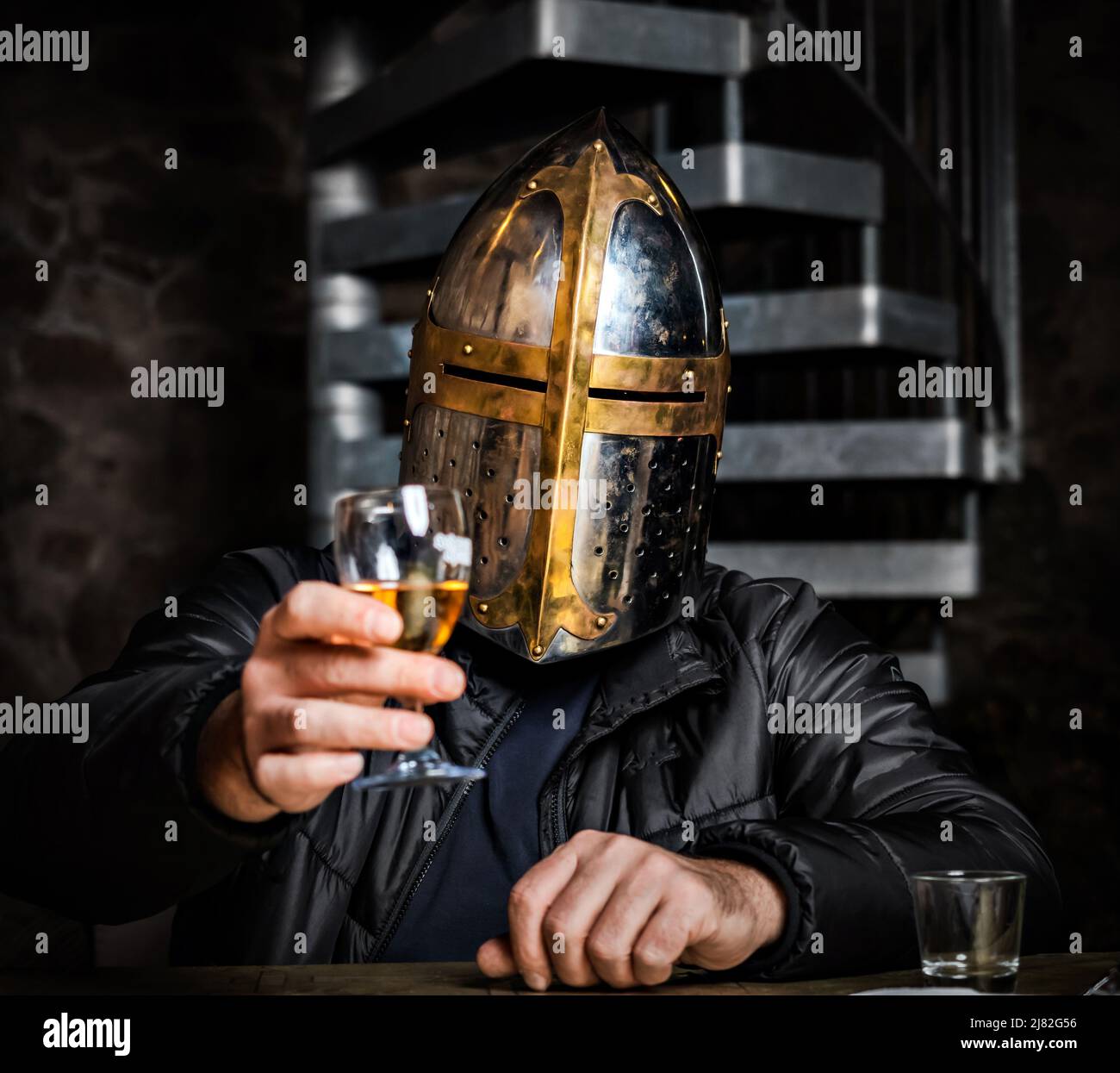 A man in a medieval iron knight's helmet. Armor Stock Photo - Alamy