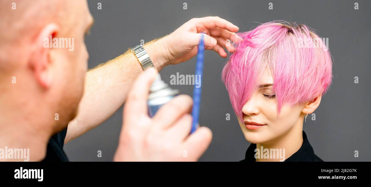 Barber using hair spray fixating hi-res stock photography and images ...