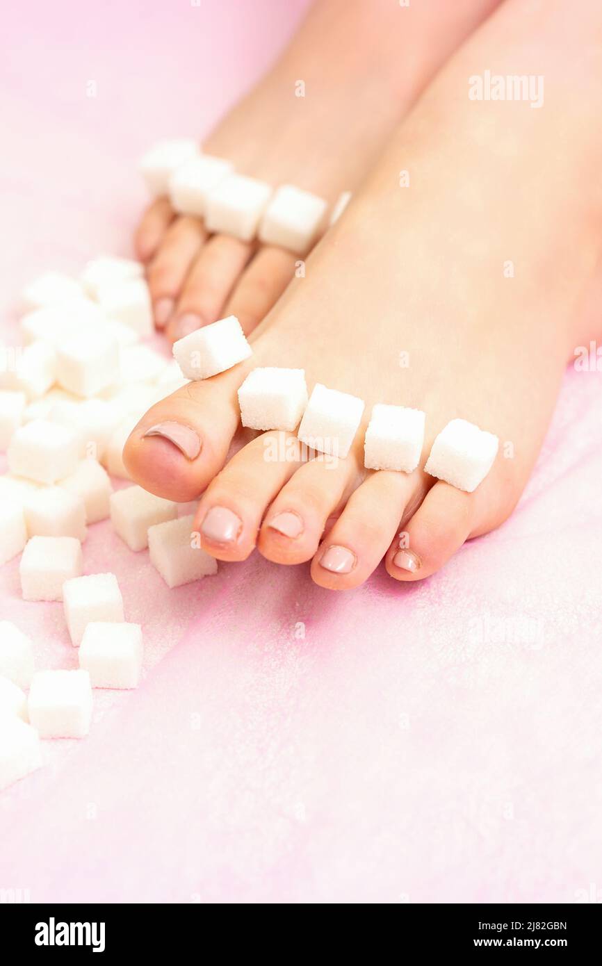 The concept of epilation, waxing. Sugar cubes lying down in a row on ...