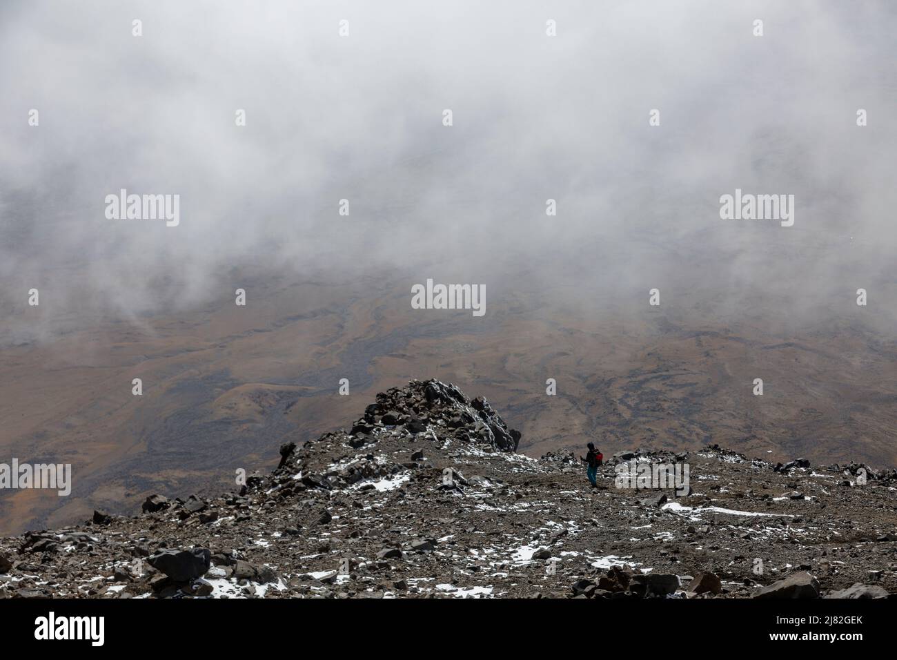 Tourist hikes on the summit of the snow-capped and dormant compound ...