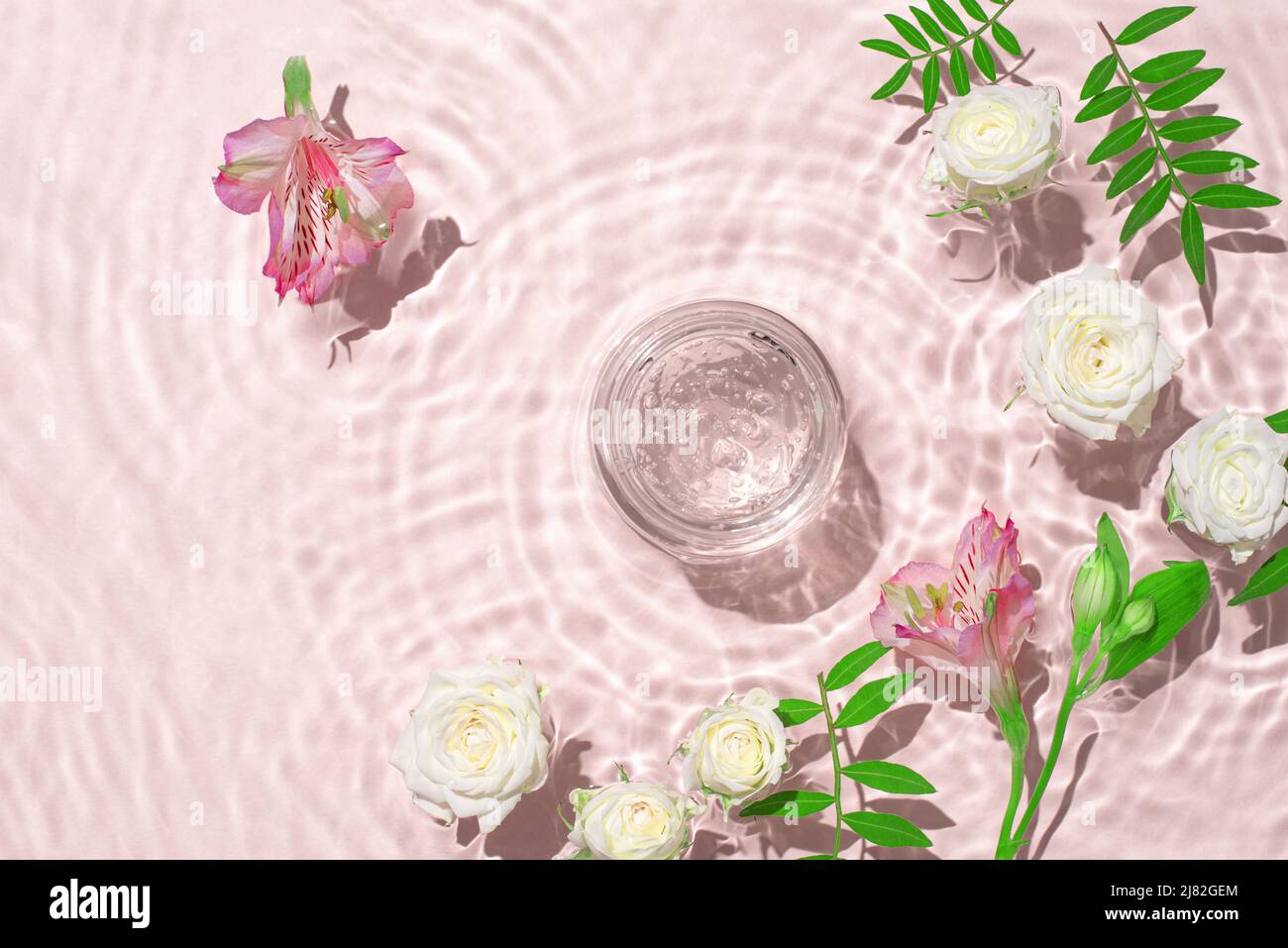 Jar of hydrating gel and flowers Stock Photo - Alamy